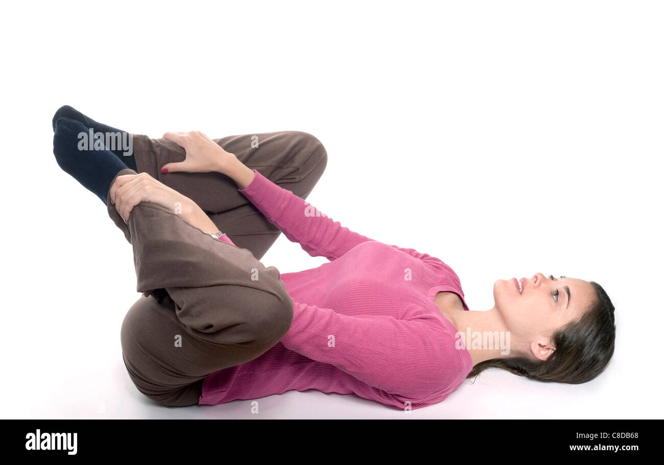 Caucasian woman lying on back and stretching legs Stock Photo - Alamy