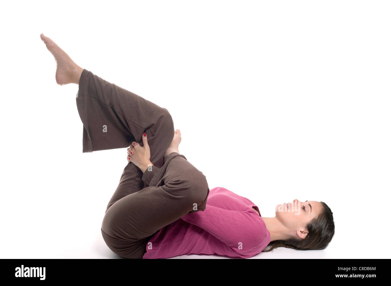 Caucasian woman lying down on back stretching Stock Photo - Alamy