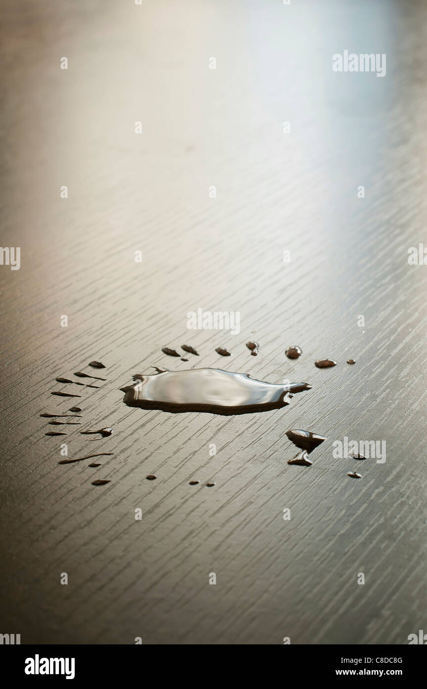 Spilled water on a table. Droplets around Stock Photo - Alamy