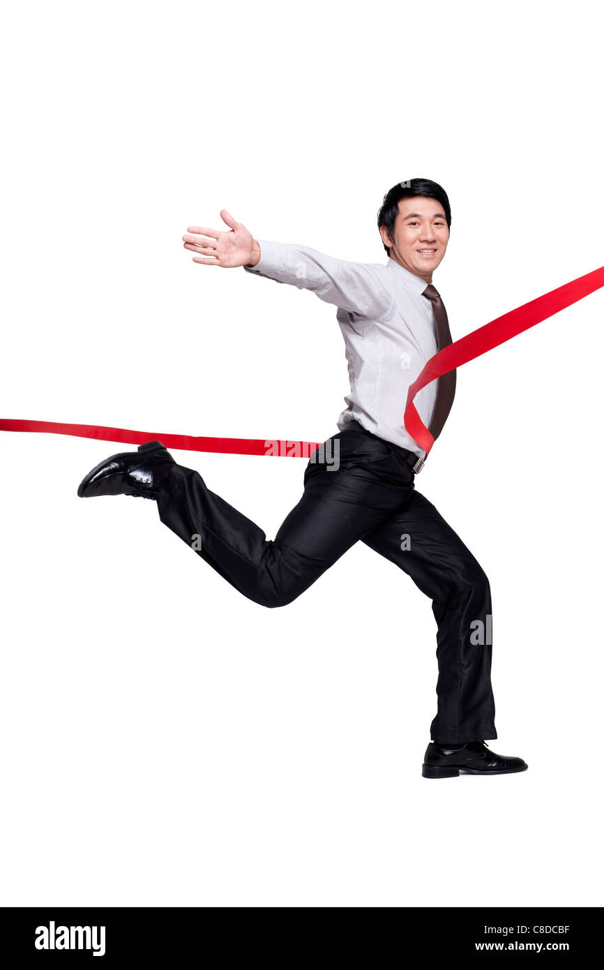 Businssman Running Across the Finish Line Stock Photo - Alamy
