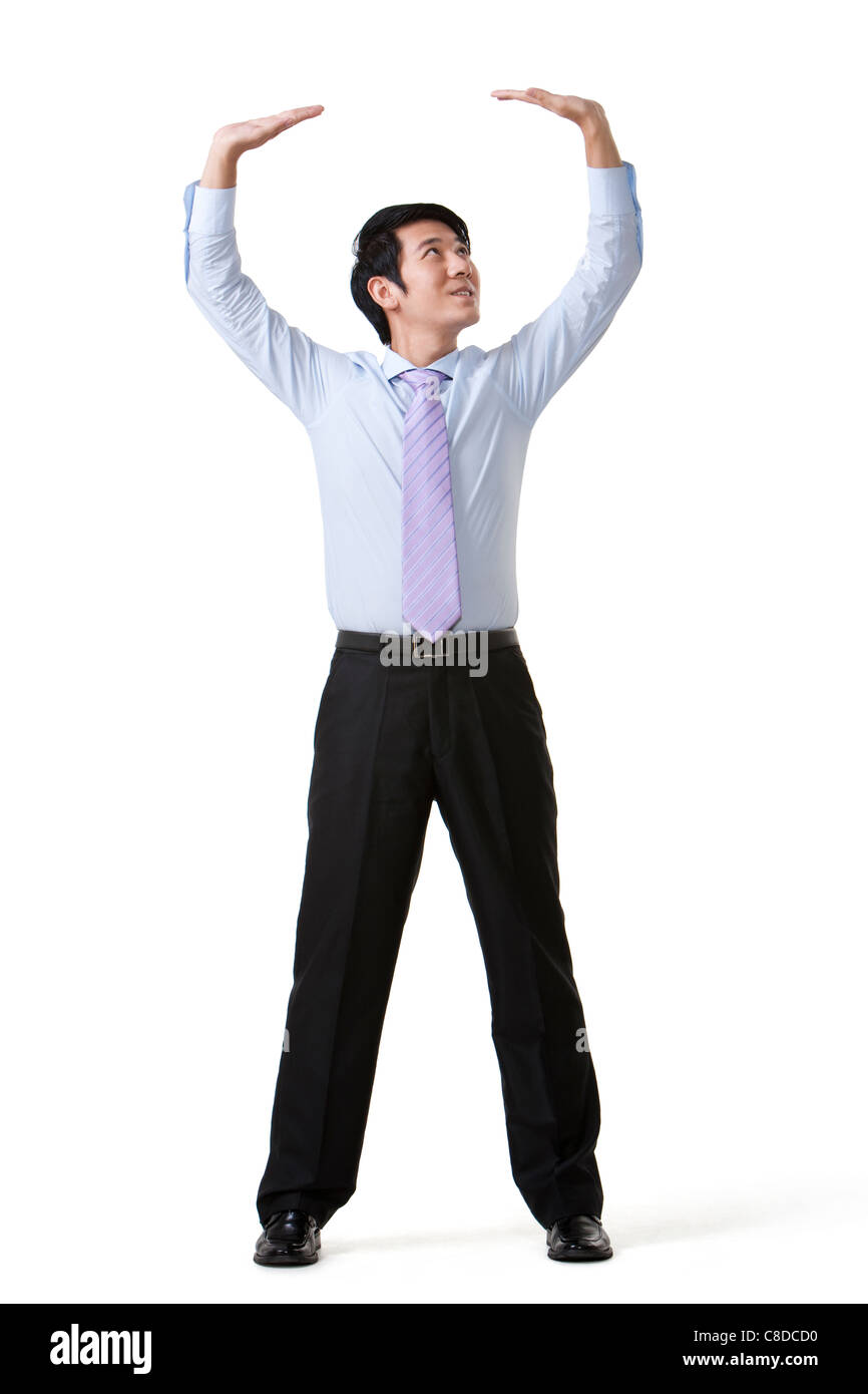 Businessman Carrying an Object Over His Head Stock Photo - Alamy