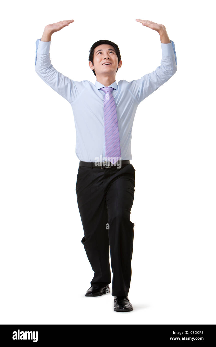 Businessman Carrying an Object Over His Head Stock Photo - Alamy