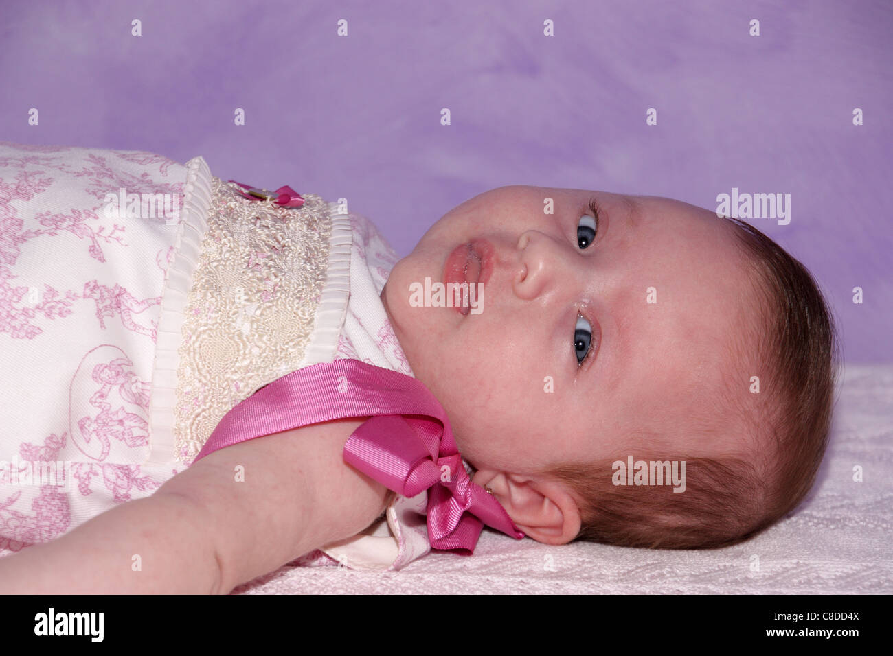Close up of three year old child with a purple background Stock Photo ...