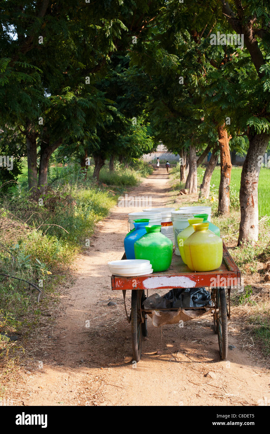 Indian water pots on a cart on a tree lined track. Andhra Pradesh ...