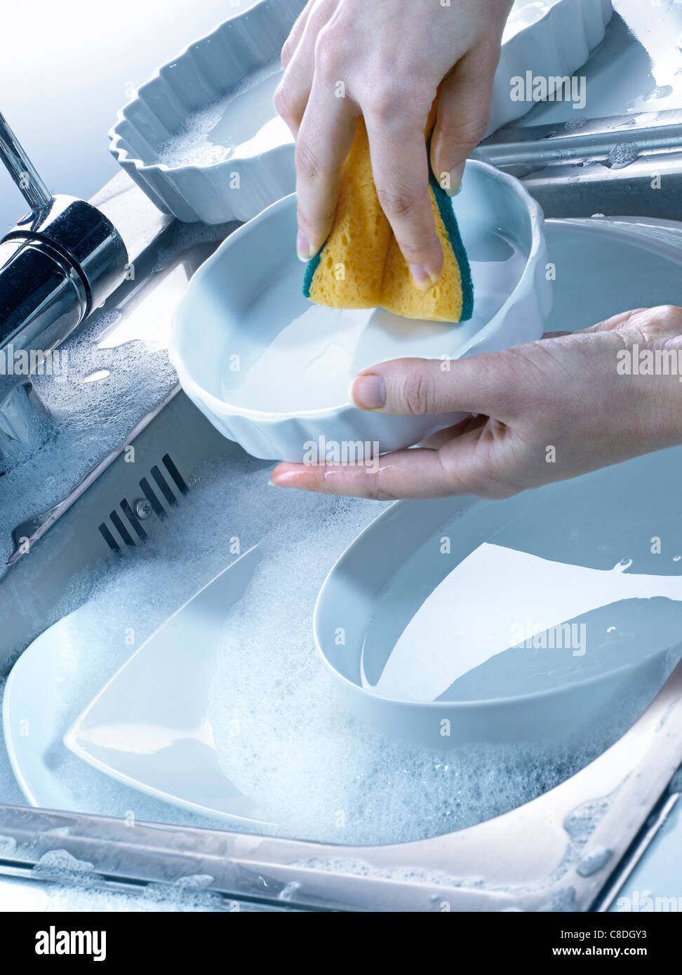 Washing the dishes in the sink Stock Photo - Alamy