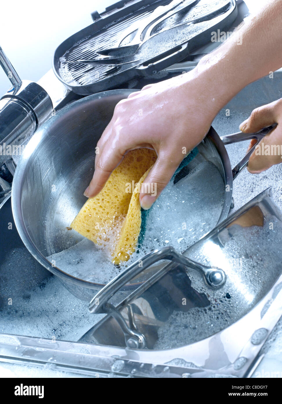 Hand washing dishes in sink hi-res stock photography and images - Alamy
