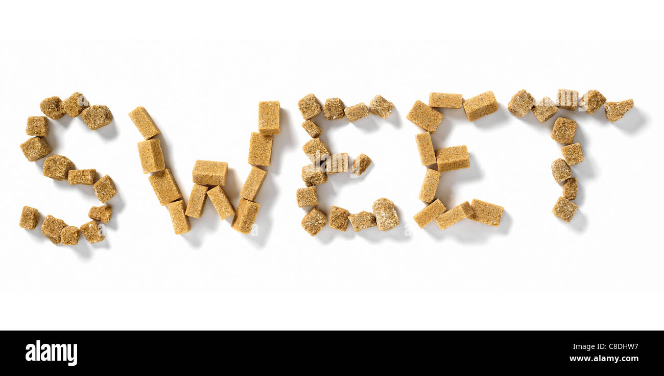 Sweet written with brown sugar lumps Stock Photo - Alamy