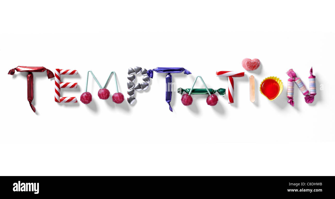 Temptation written with candies Stock Photo - Alamy