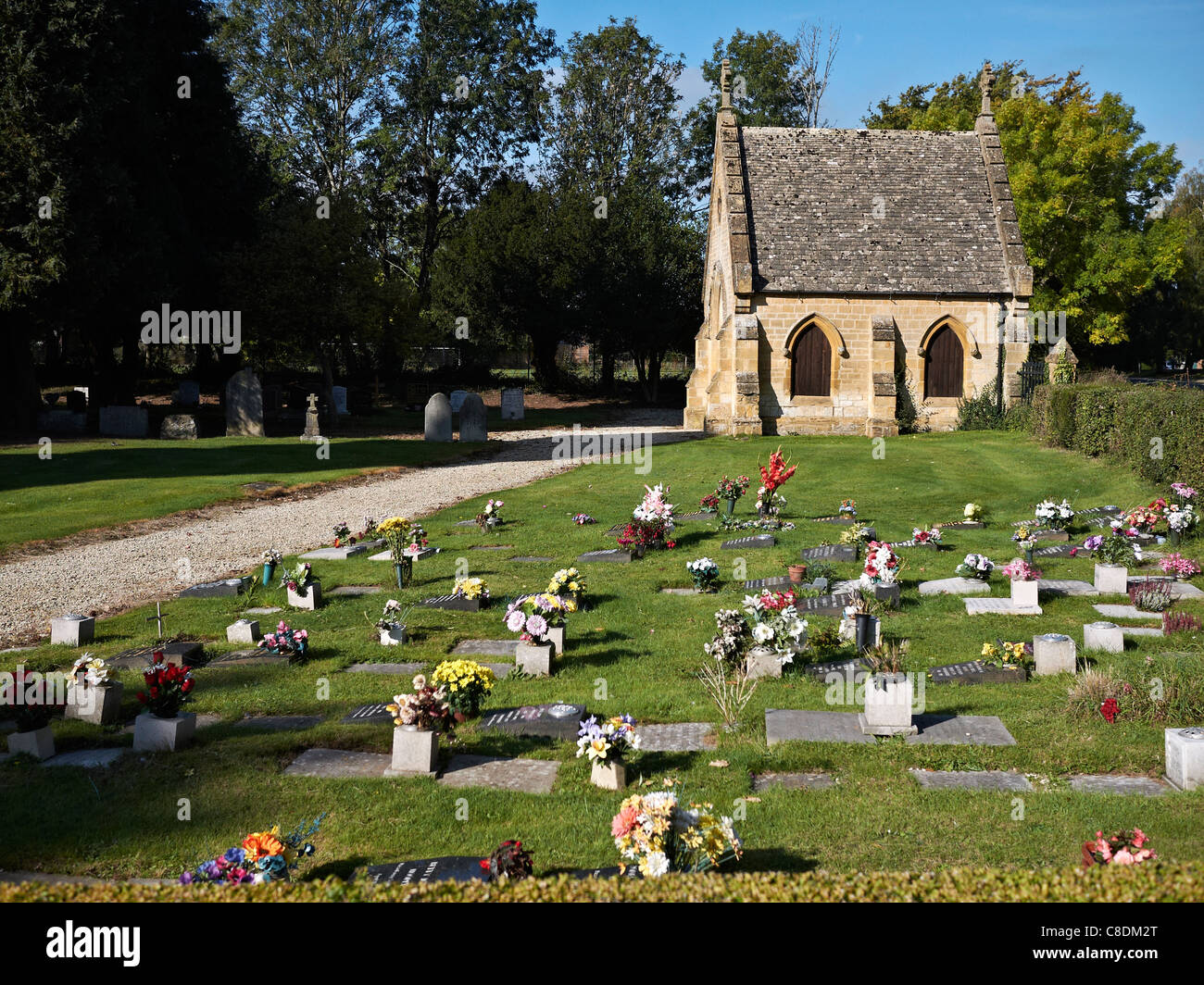 Moreton in the Marsh small church and flower adorned graveyard ...