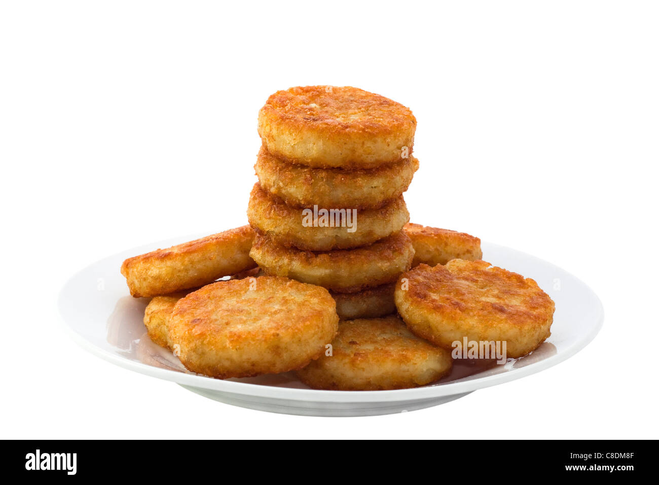 Hash browns on white plate. Image is isolated on white background with ...