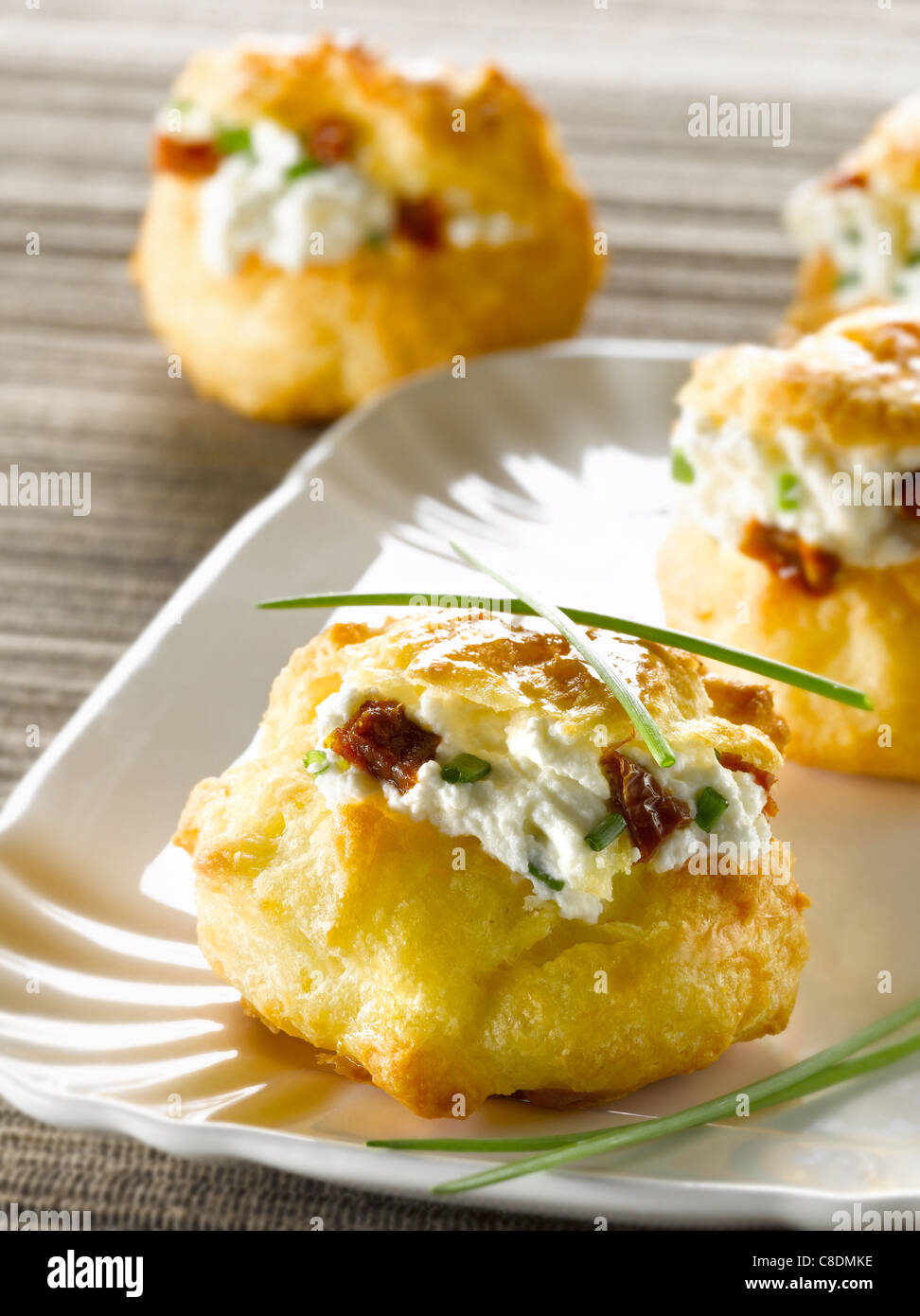 Ricotta,confit tomato and chive Profiteroles Stock Photo - Alamy