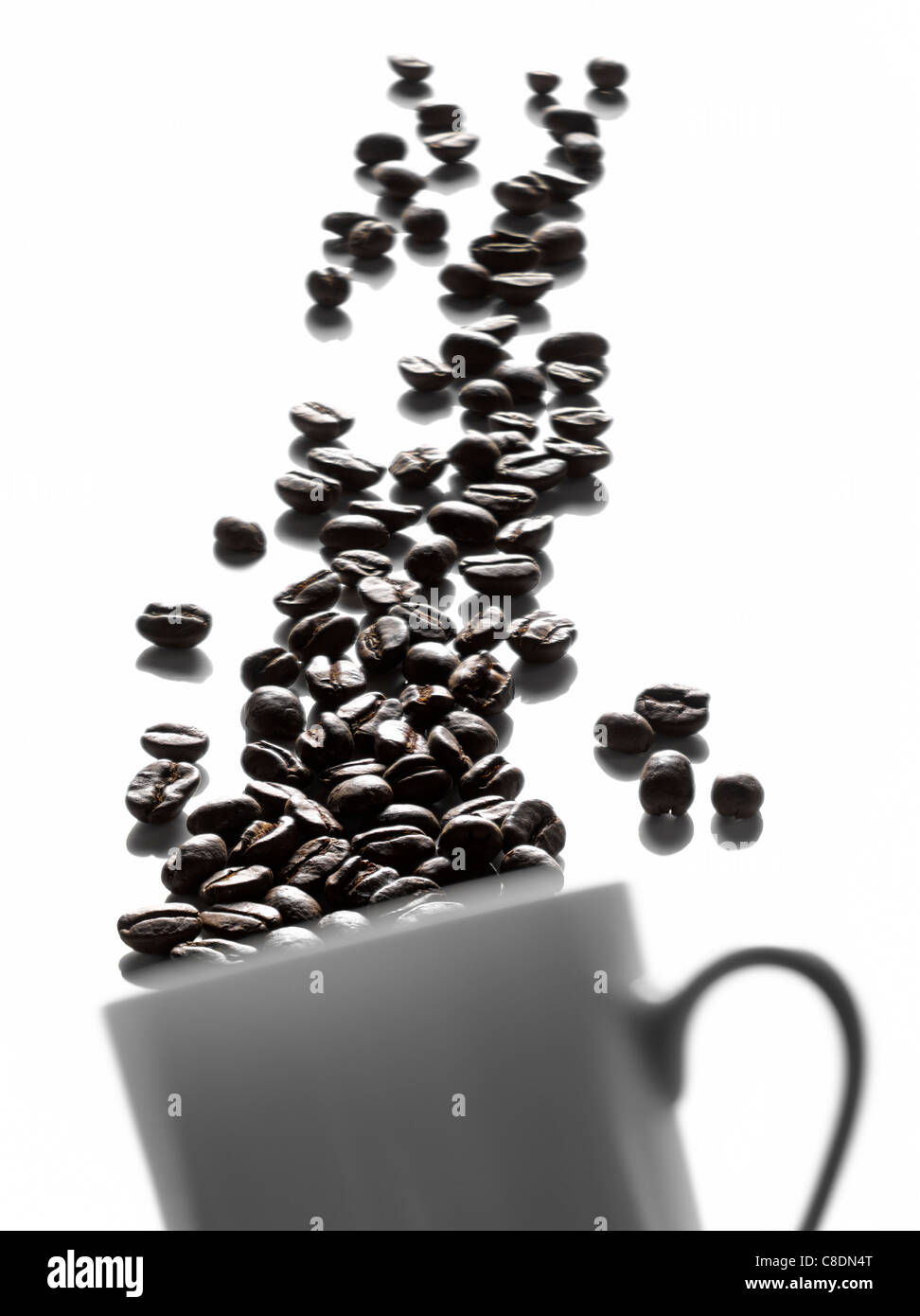 Spilt cup of coffee beans Stock Photo - Alamy