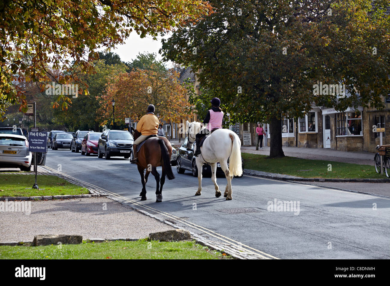 Horse and riders on the street. An English rural scene at Broadway ...