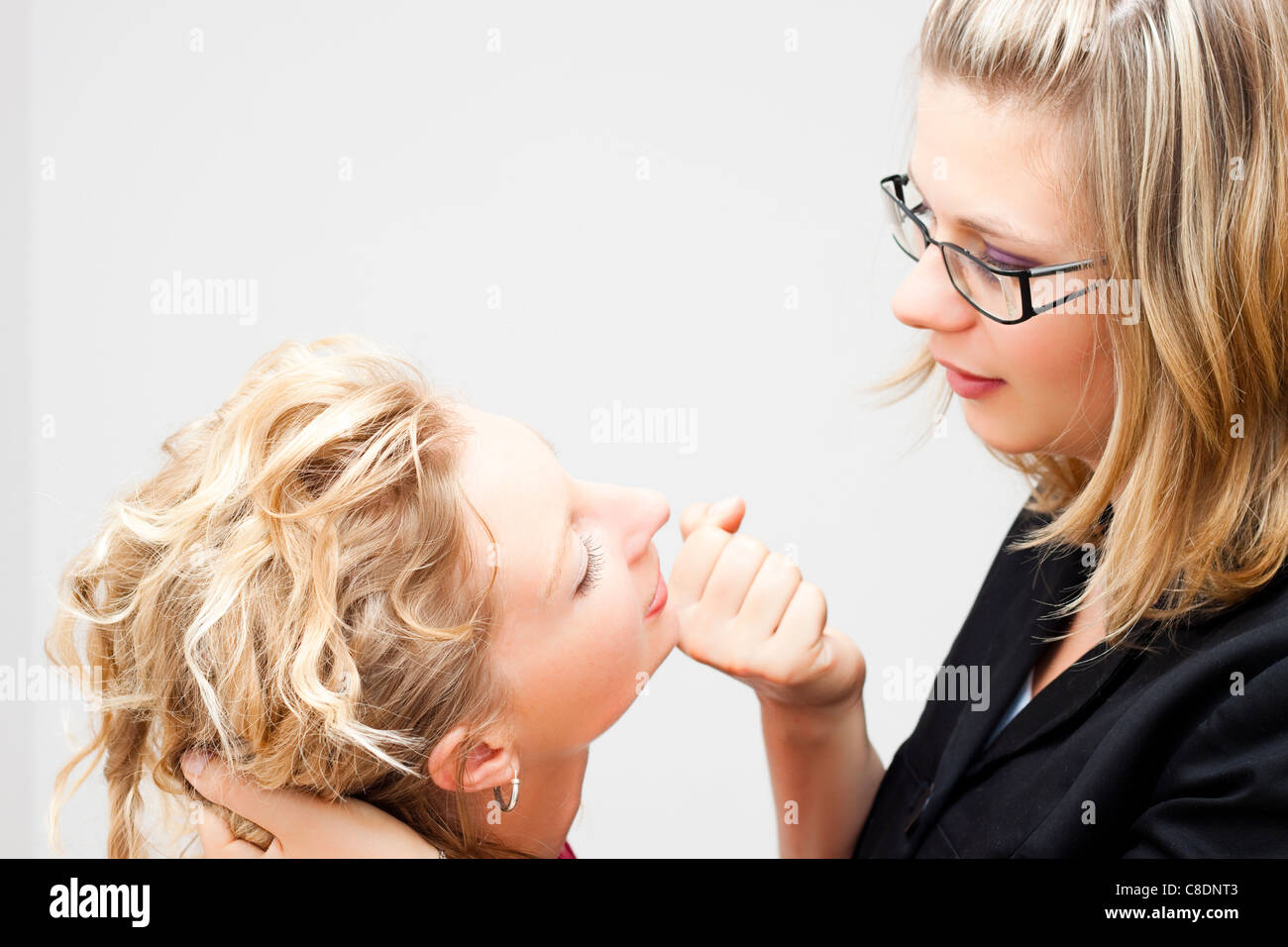 Two young business women fighting Stock Photo - Alamy
