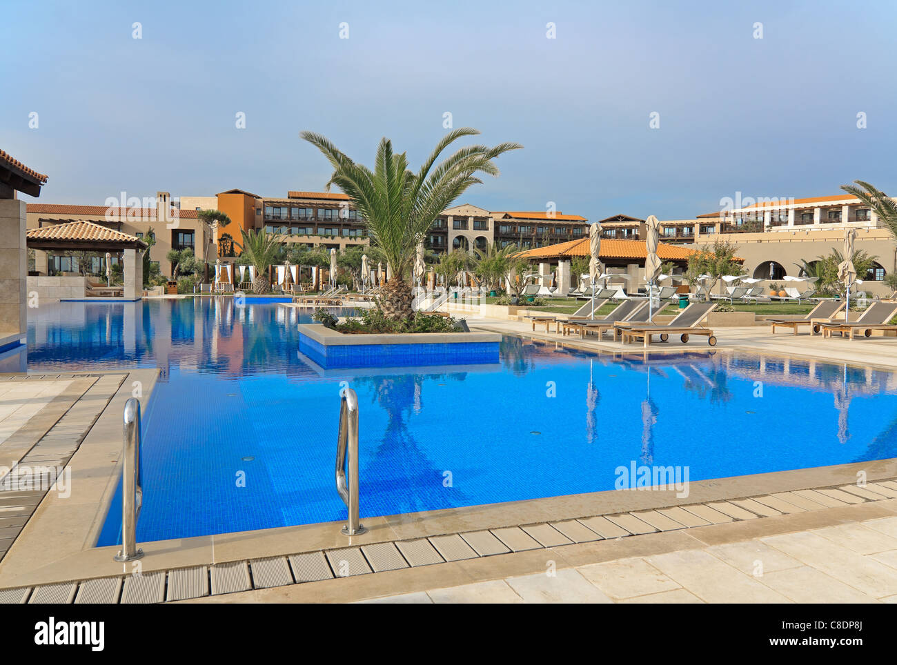 Luxury Resort Pool and chairs at hotel resort in Greece Stock Photo - Alamy
