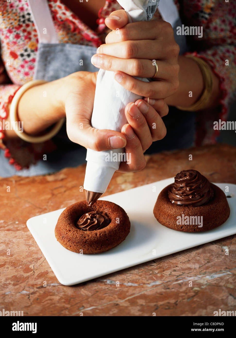 Adding the chocolate cream Stock Photo - Alamy