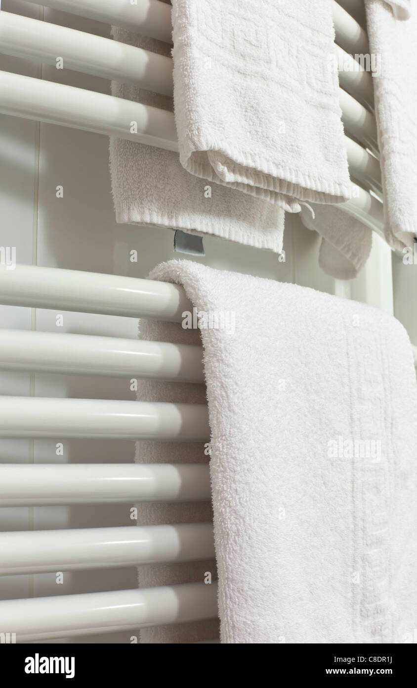 white towels hanging on radiator rail in bathroom Stock Photo - Alamy