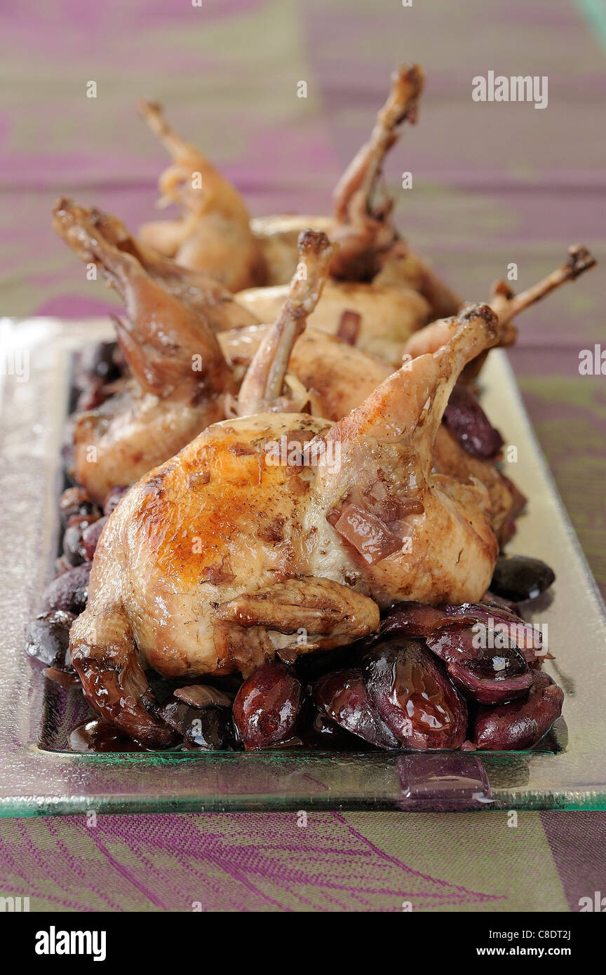 Roast quail with caramelized grapes Stock Photo - Alamy