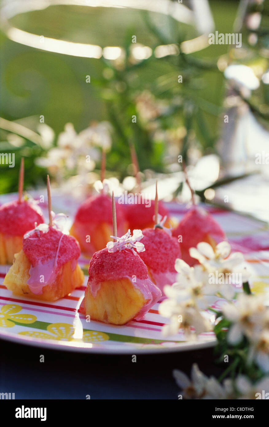 Pineapple and strawberry Tagada candy skewers Stock Photo - Alamy