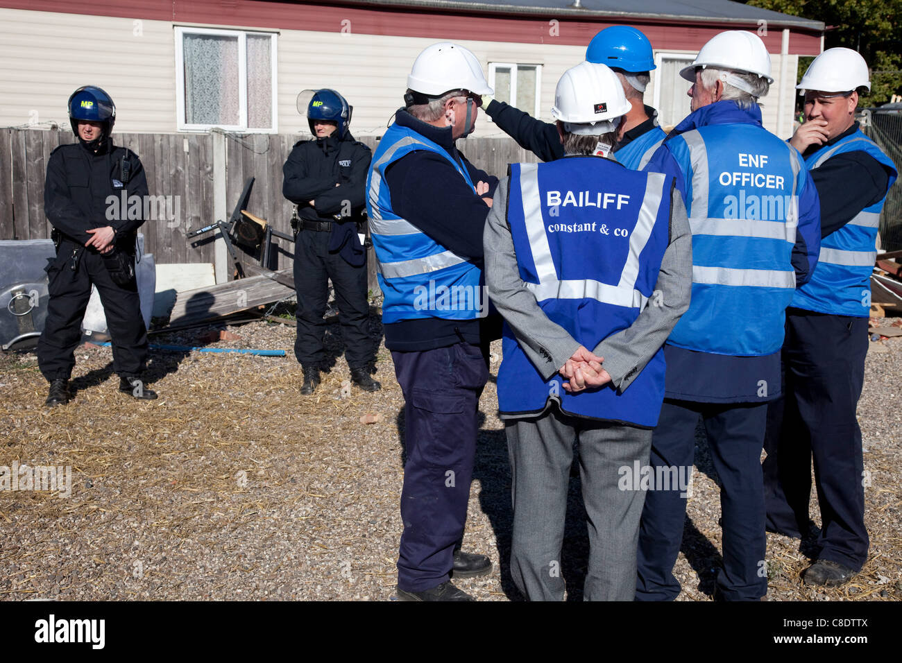 Bailiffs at Dale Farm site prior to eviction, a Romany Gypsy and Irish ...