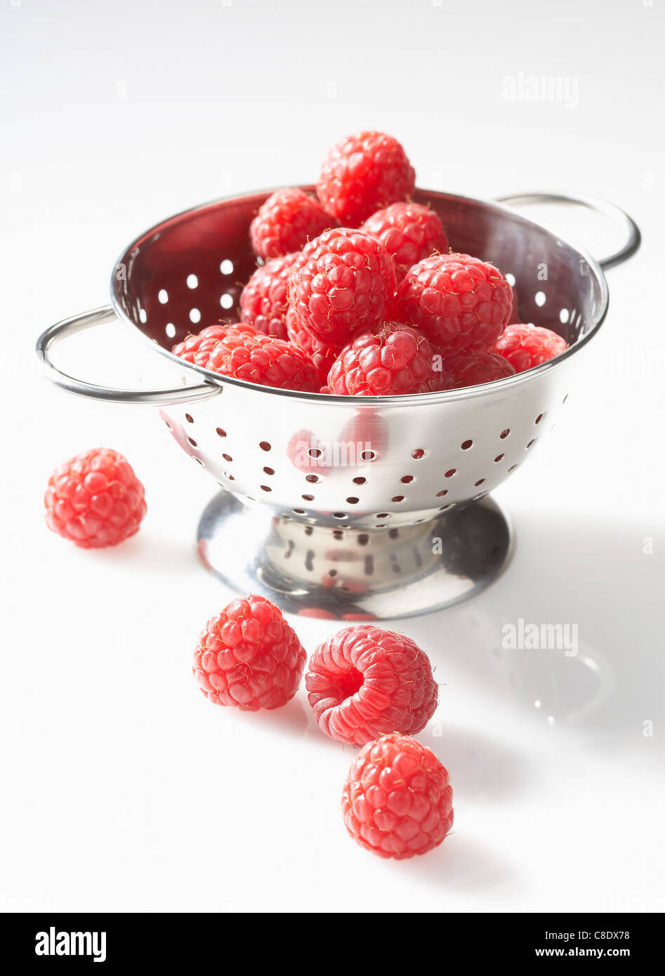 Colander of raspberries Stock Photo - Alamy