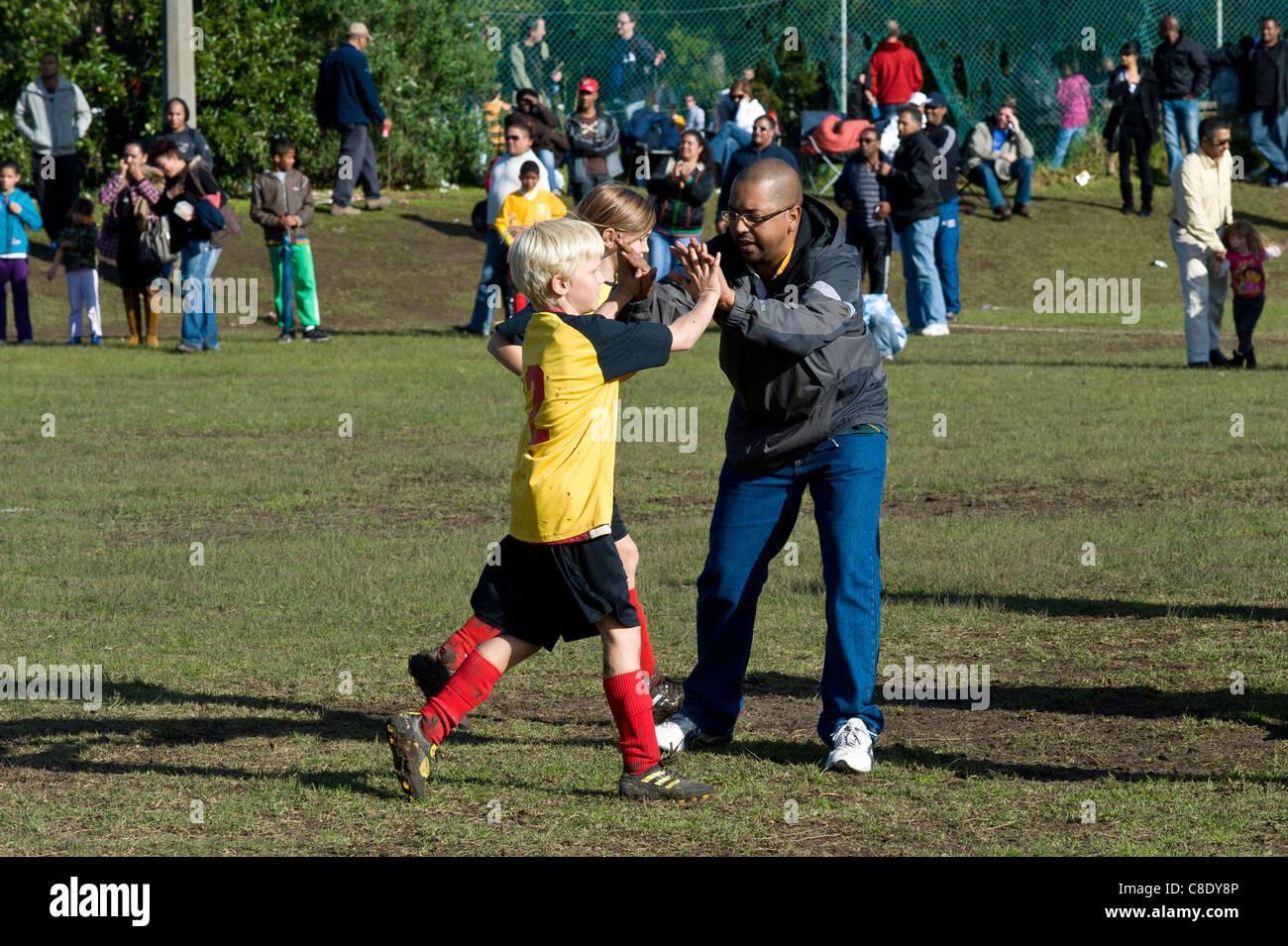 Youth player and coach give a high five Rygersdal Football club Cape ...
