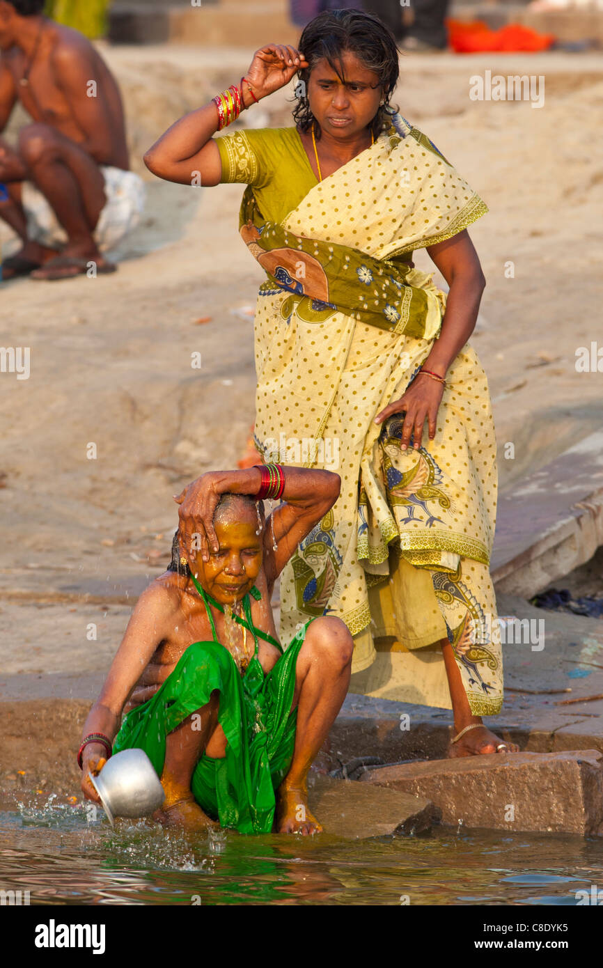 Indian Hindu pilgrims bathing in The Ganges River at Dashashwamedh Ghat ...