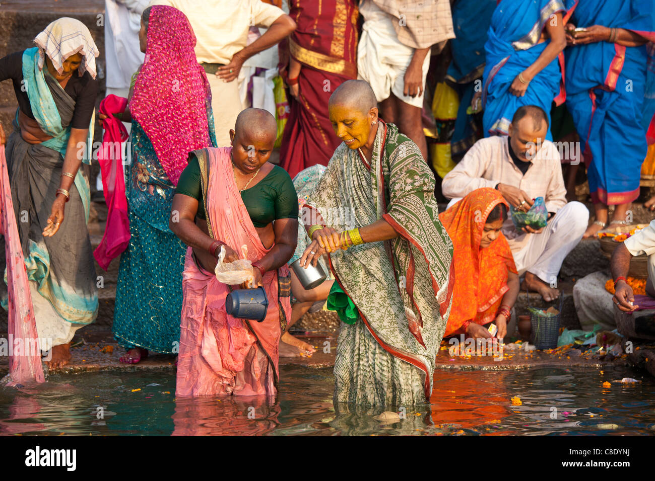 Indian Hindu pilgrims bathing in The Ganges River at Dashashwamedh Ghat ...