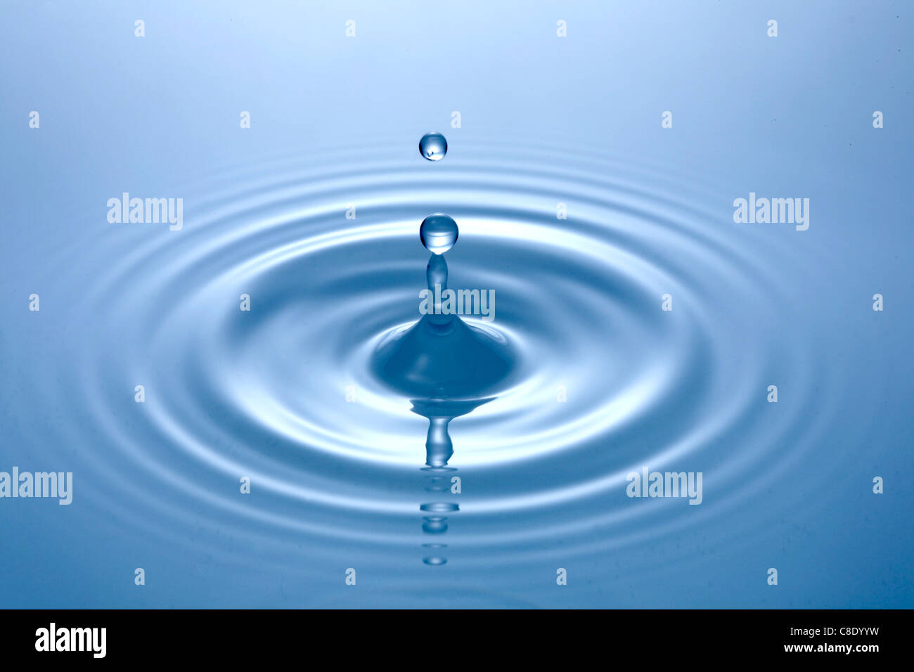 A drop of water falling in water Stock Photo - Alamy