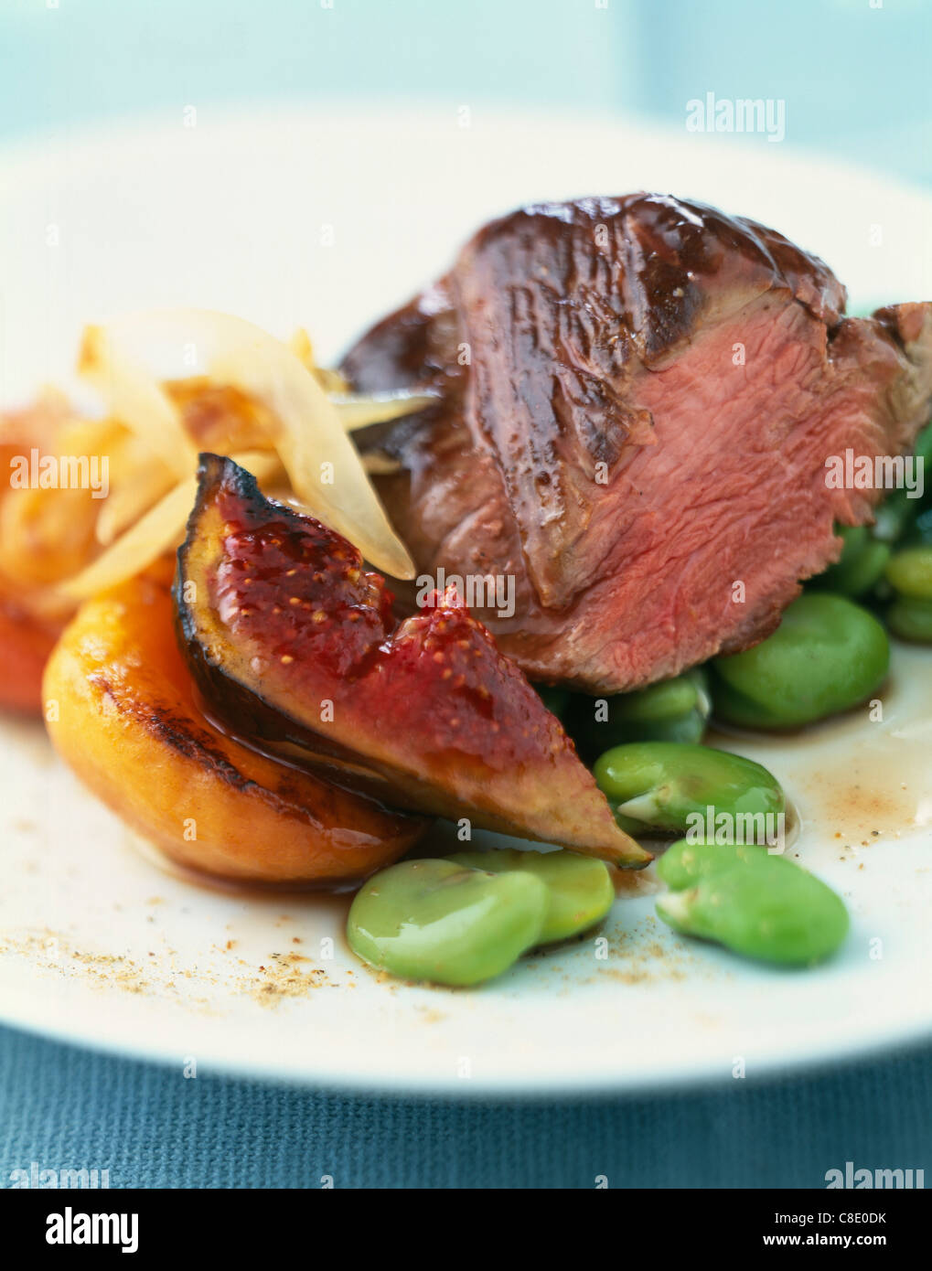 Thick ostrich steak with cardamom,stewed fruit and broad beans Stock ...