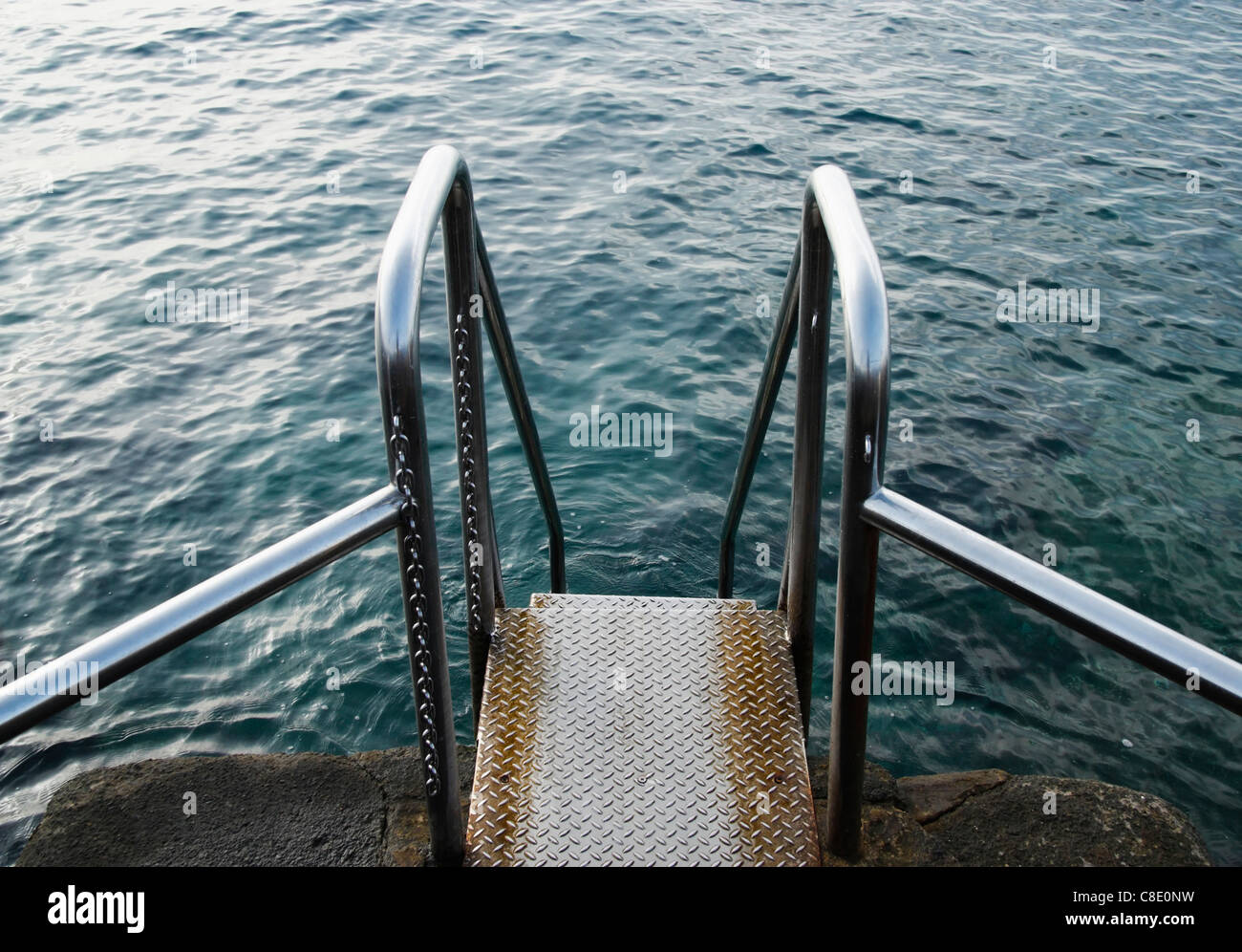Steel steps leading to sea rock pool in Spain Stock Photo - Alamy