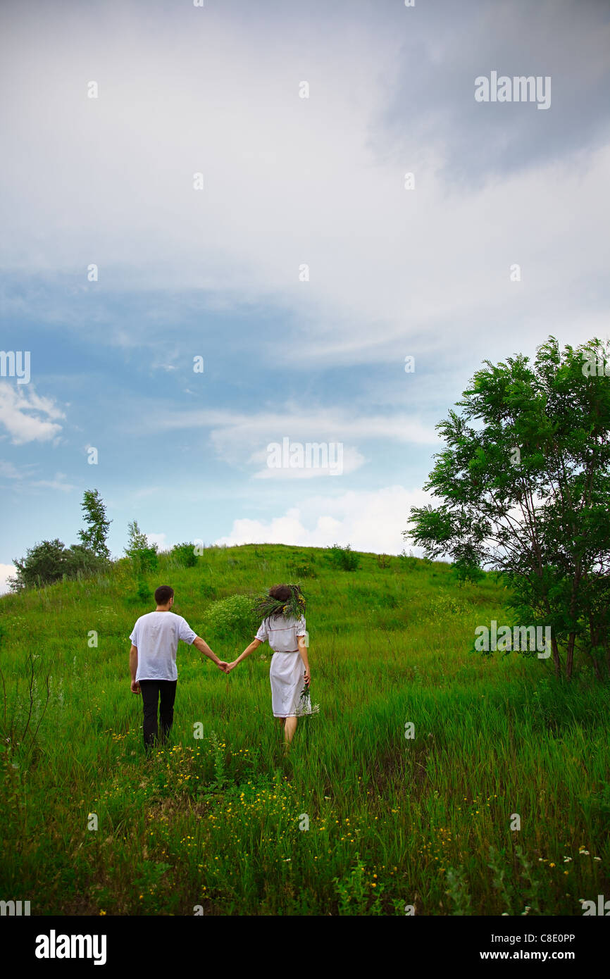 pair of man and woman walking on nature. outdoor shot Stock Photo - Alamy
