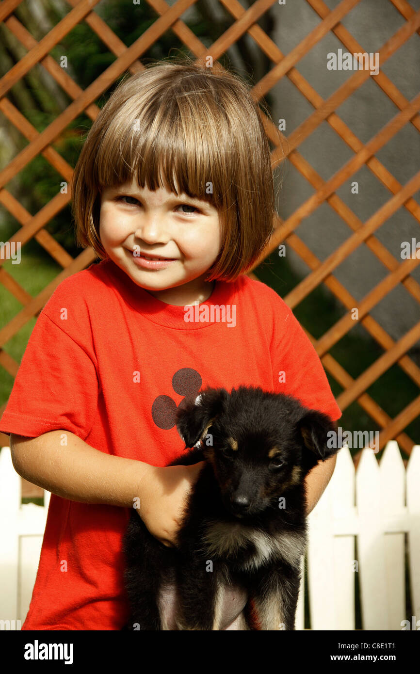 3 year old girl holding puppy dog Stock Photo - Alamy