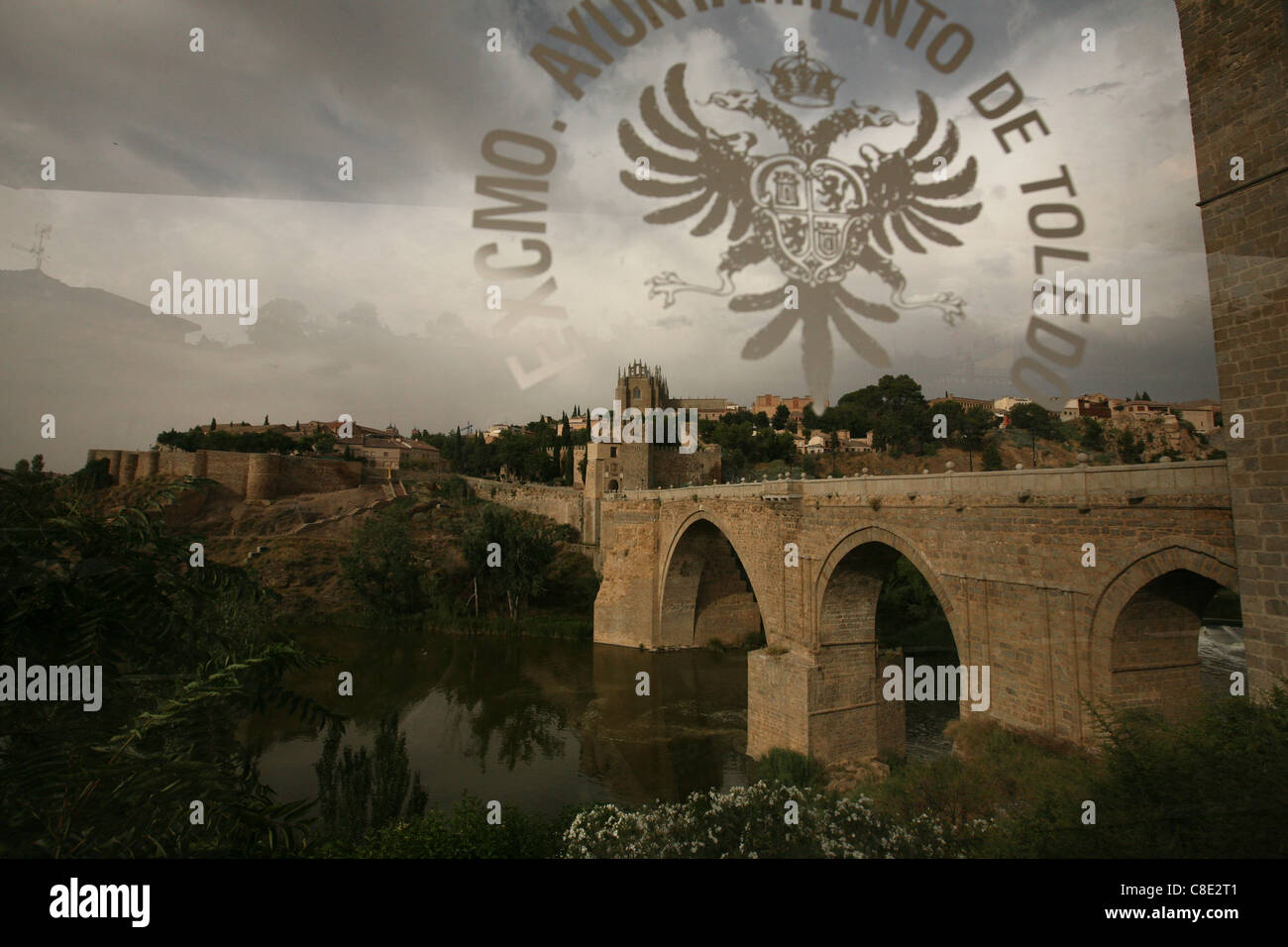 Coat of arms of Toledo on glass with panorama of the city with Puente ...