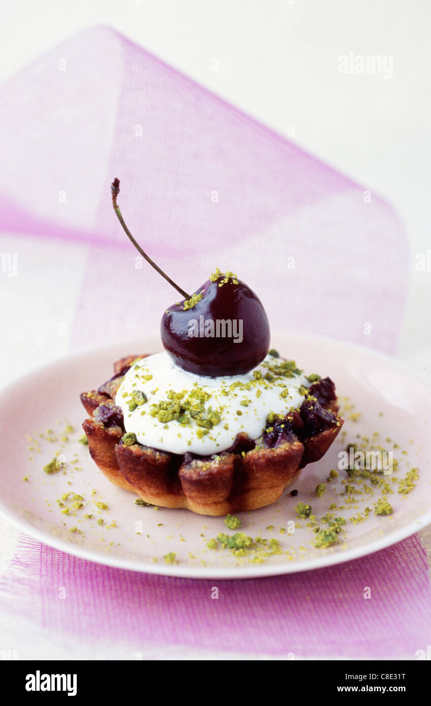 Cherry Financier with light cream and crushed pistachios Stock Photo ...
