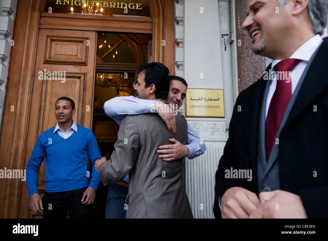 Libyan nationals and diplomatic staff celebrate on the steps outside ...