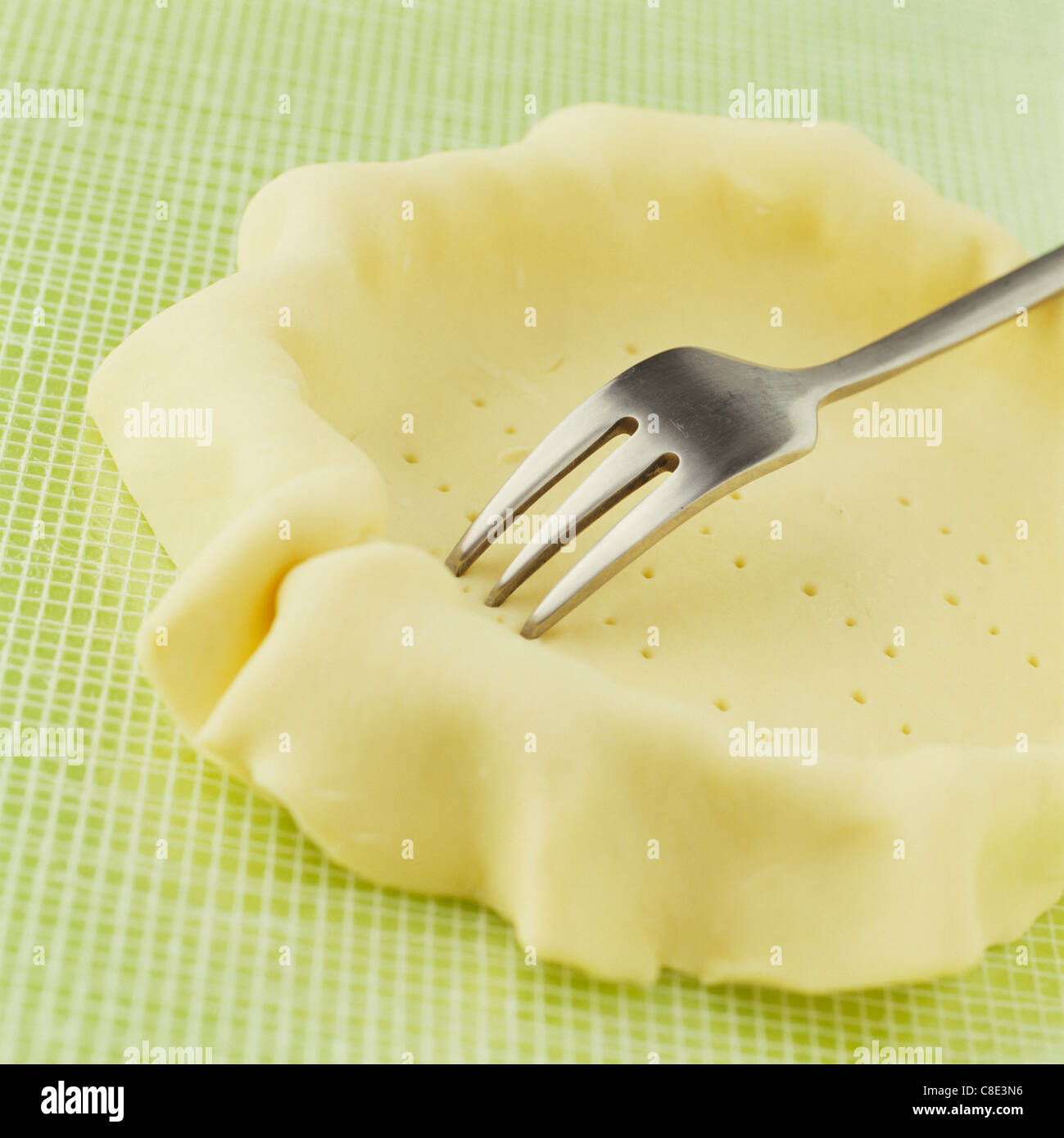 Pricking the uncooked pastry with a fork Stock Photo - Alamy