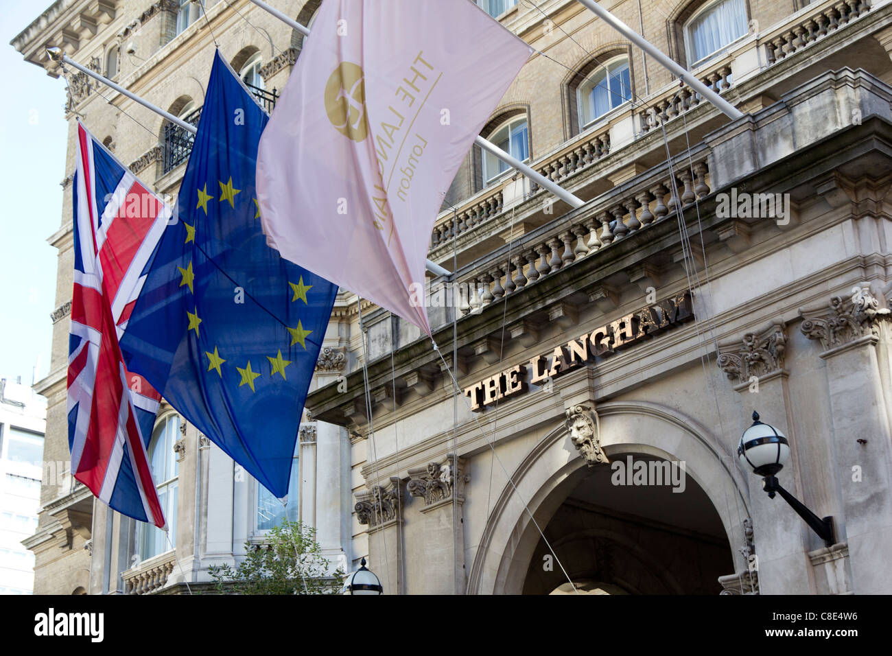 Flags flying at the entrance to The Langham Hotel, Upper Regent Street ...