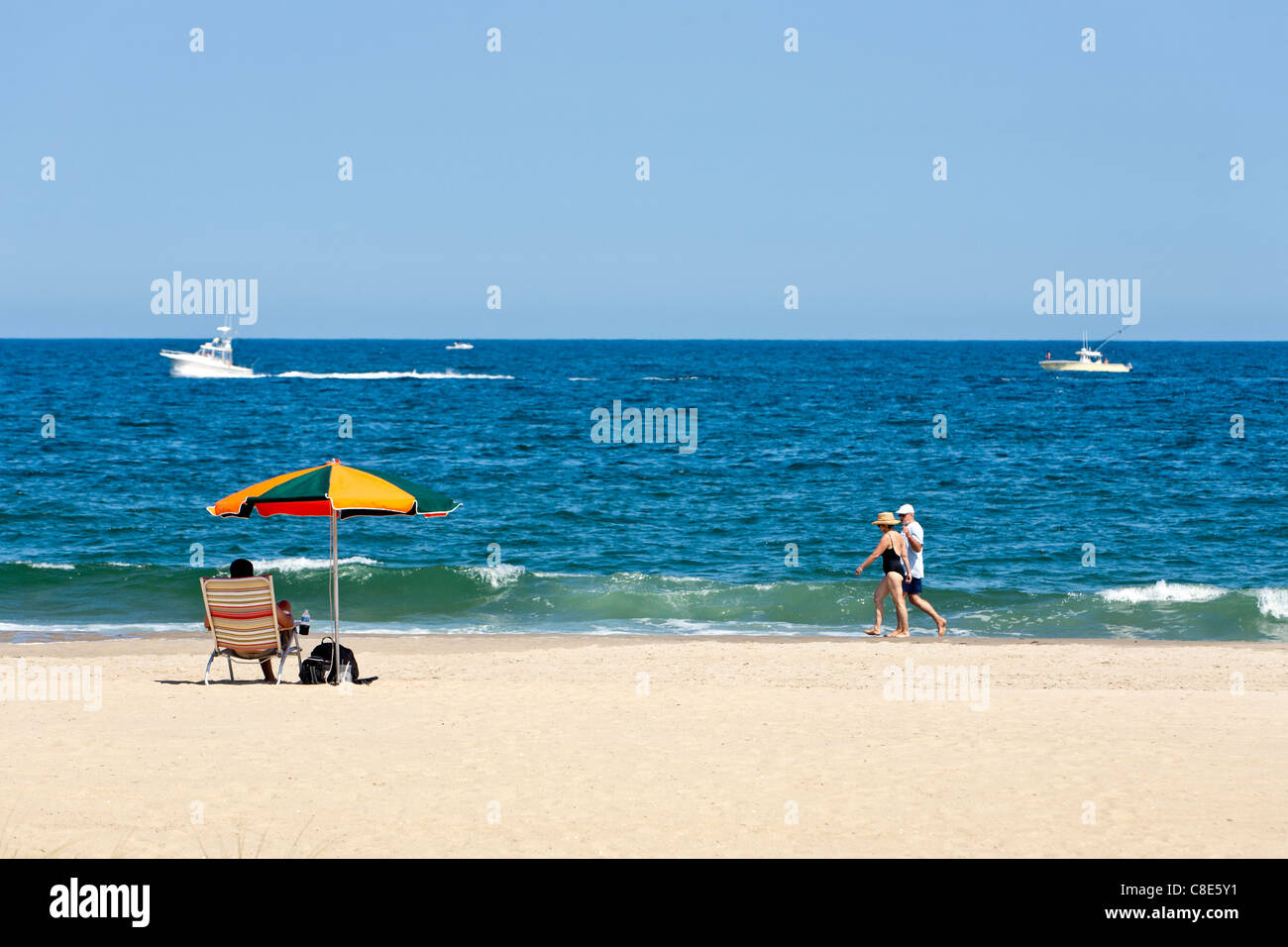 A summer day at the beach with people walking and relaxing Stock Photo ...