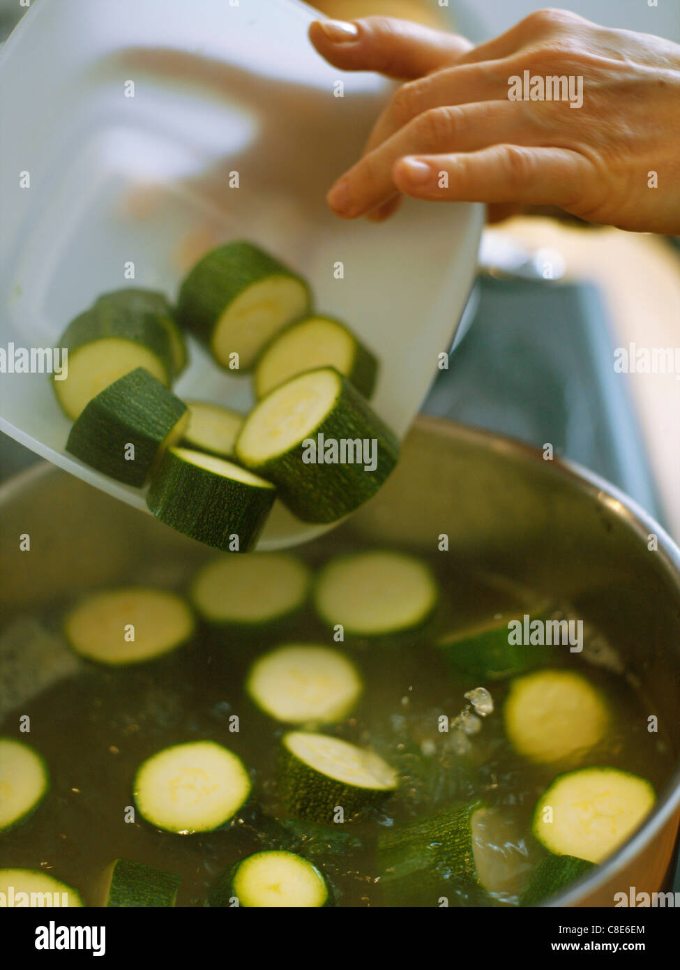 Cooking the zucchinis in a saupan of boiling water Stock Photo - Alamy