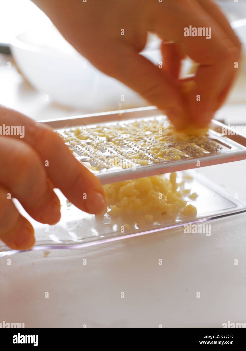 Grating fresh ginger Stock Photo - Alamy