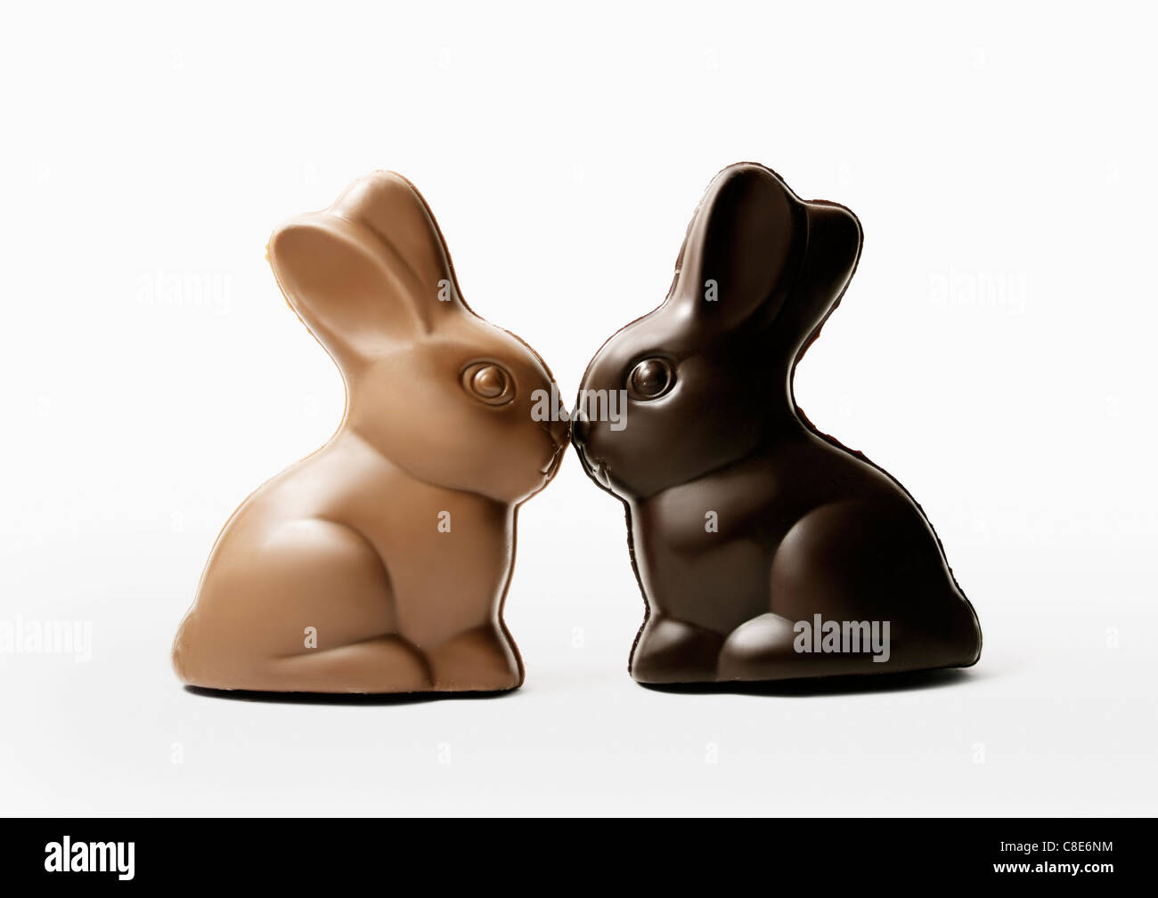 Two chocolate rabbits kissing eachother Stock Photo - Alamy