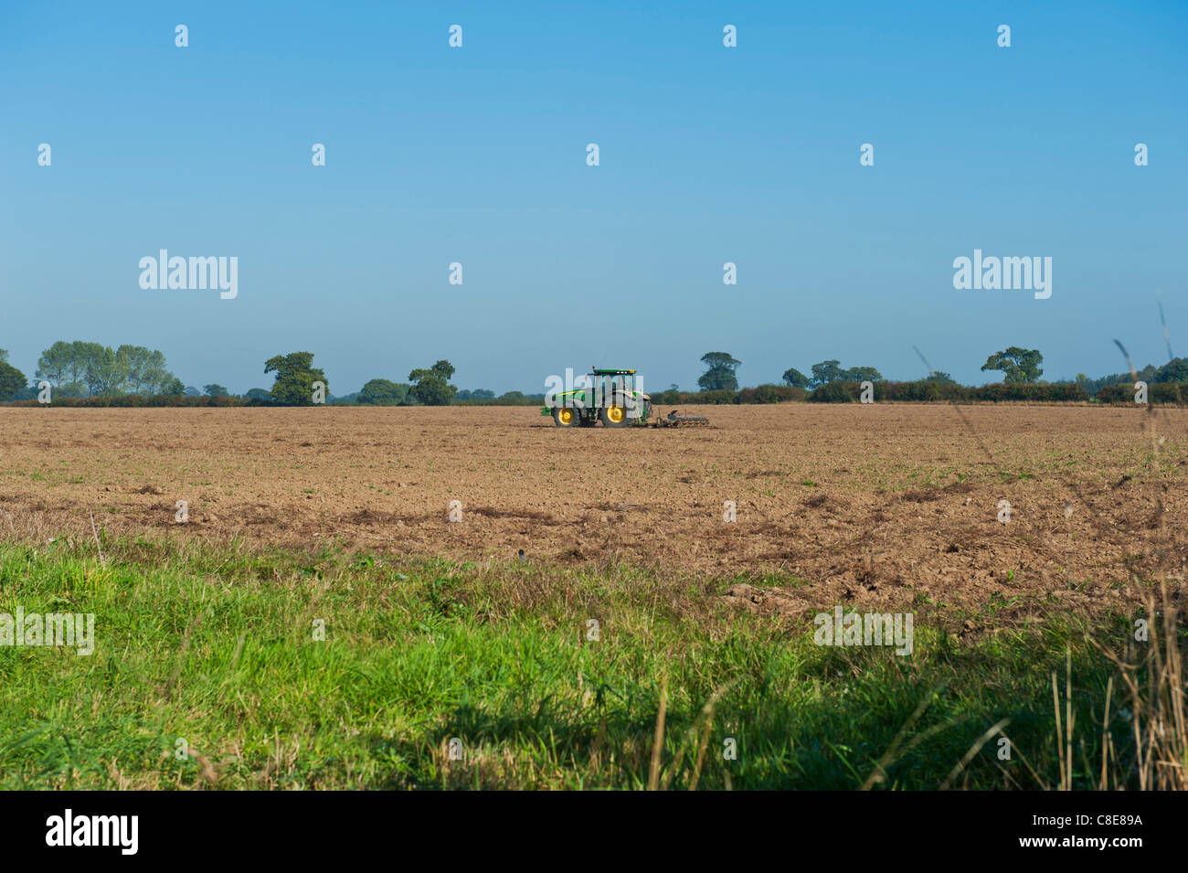 Tractor ploughing field ready for sowing crops Stock Photo - Alamy