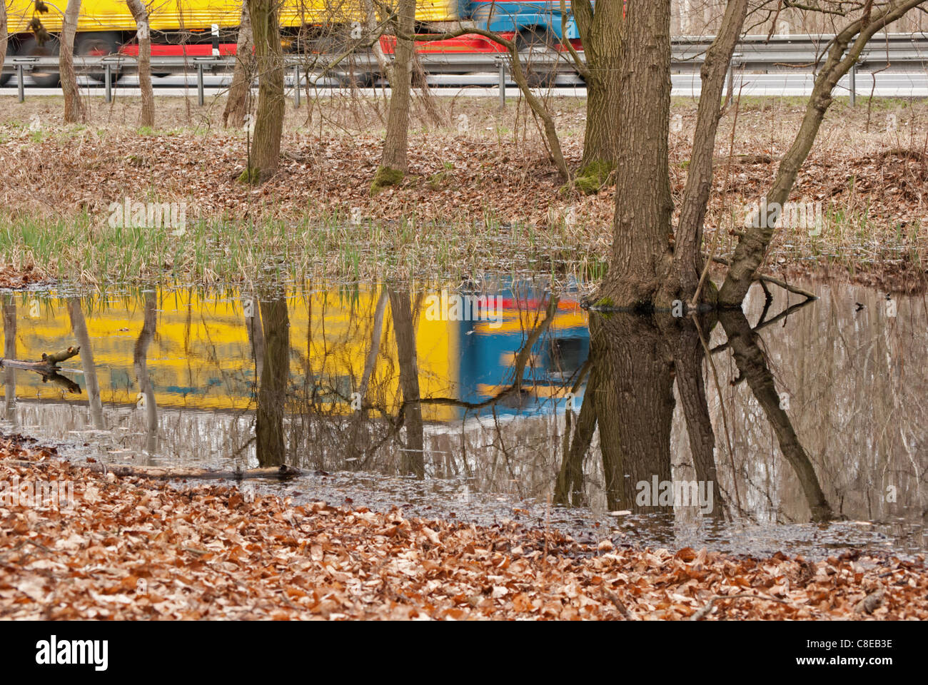 truck on motorway, reflection in pond Stock Photo - Alamy