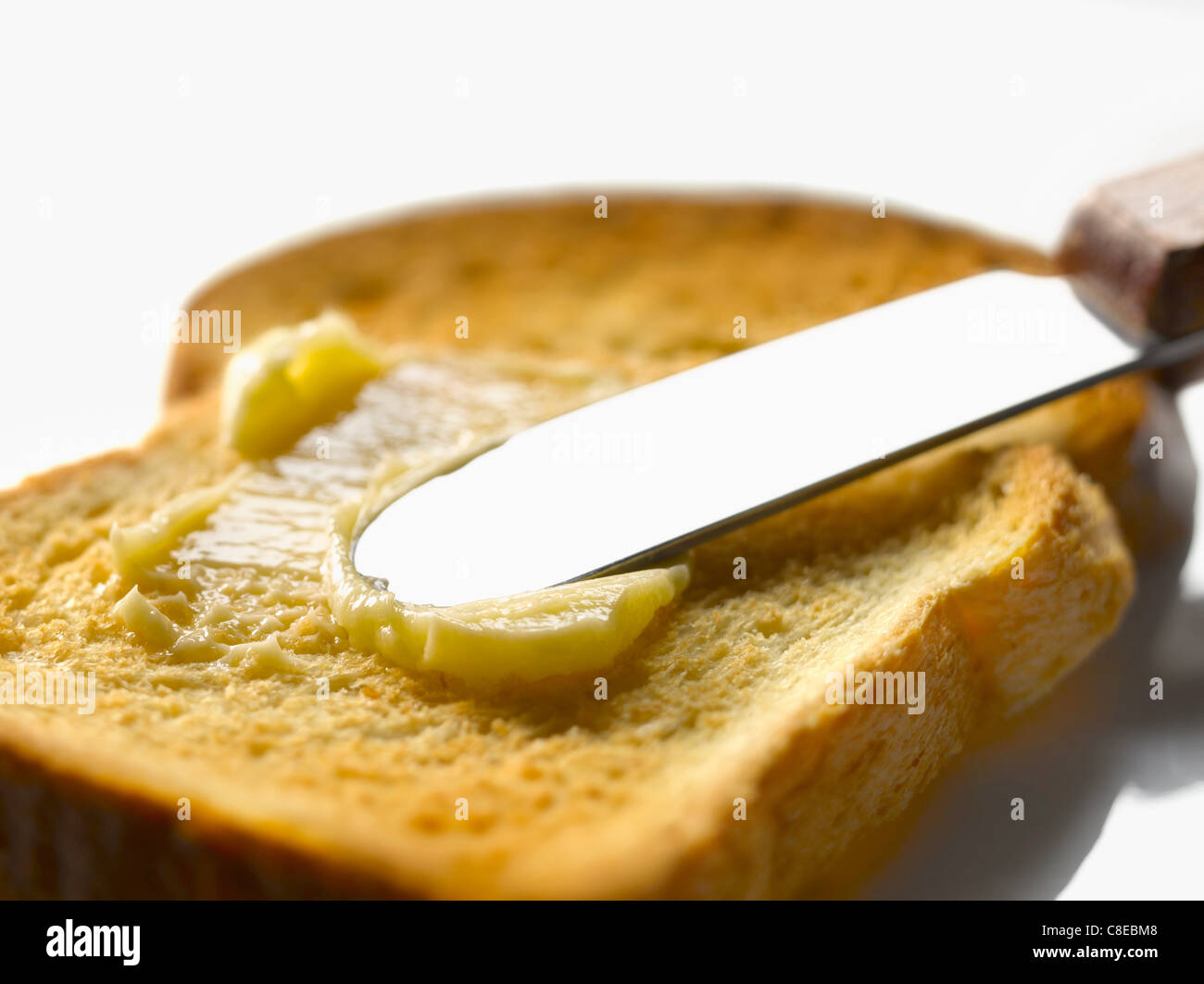 Spreading butter onto a biscotte Stock Photo - Alamy