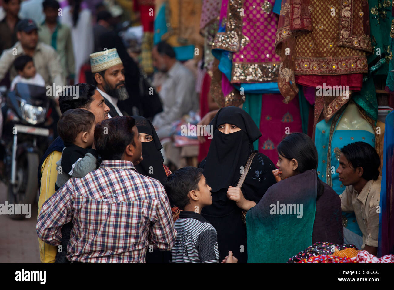 Muslim family out shopping in clothes shop in city of Varanasi, Benares ...