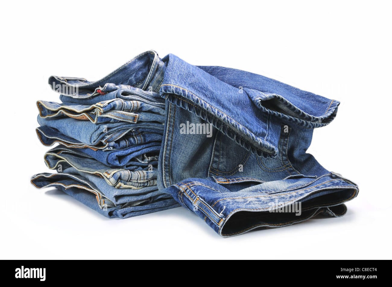 Pile of blue denim jeans isolated on white background Stock Photo - Alamy