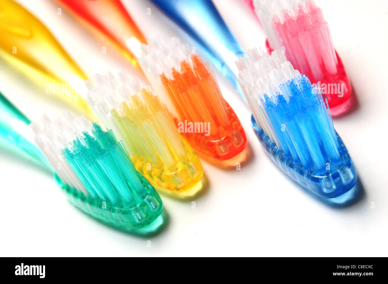 Five multicolored toothbrushes on white background Stock Photo - Alamy