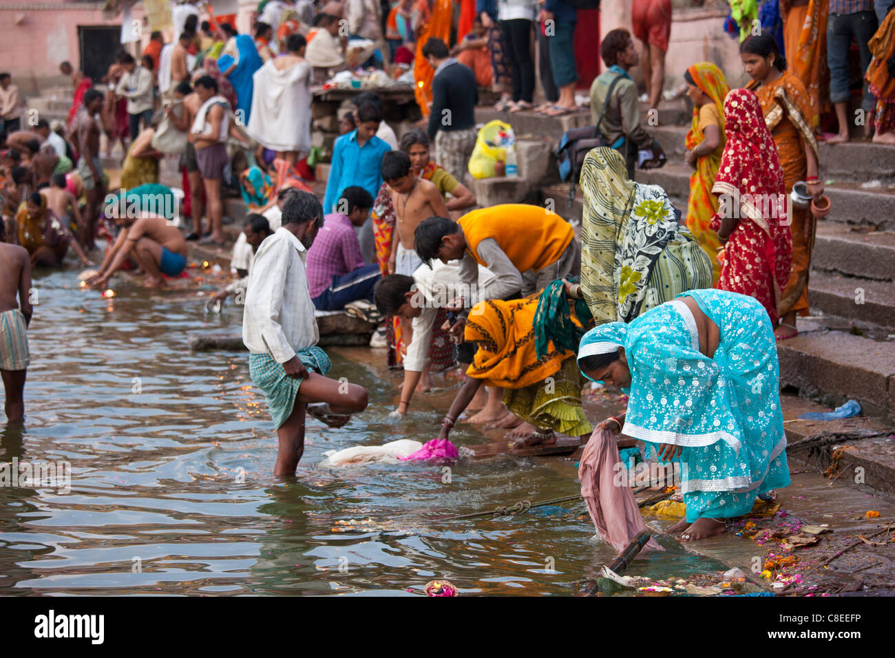 Indian Hindu pilgrims bathing in The Ganges River at Dashashwamedh Ghat ...