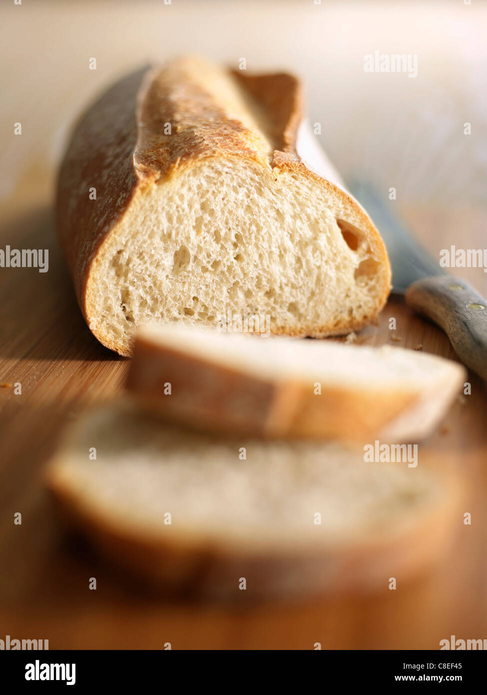 Slicing a farmhouse loaf of bread Stock Photo - Alamy
